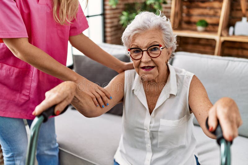 Senior Grey-haired Woman Patient Supported for Nurse and Walker at ...