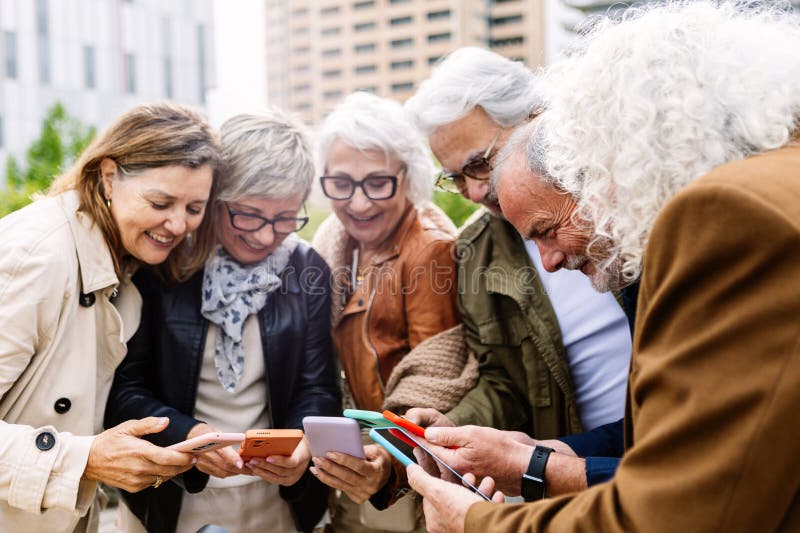 Senior Group of People Using Mobile Phone Device Standing in Circle ...