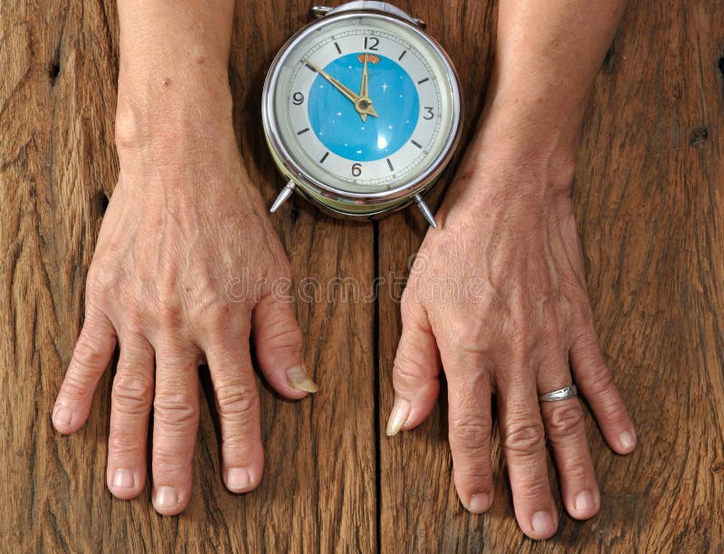 Senior Hand and Old Clock on Wood Table Stock Photo - Image of deadline ...
