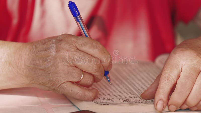 Senior Hand with Pen Doing Crossword Puzzles Stock Footage - Video of ...