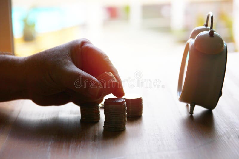 Senior Hand Put Coins on Coin Stack with Alarm Clock , Saving Concept ...