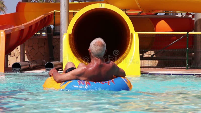 Senior Have Fun on Water Slide Stock Video - Video of dynamic, person ...