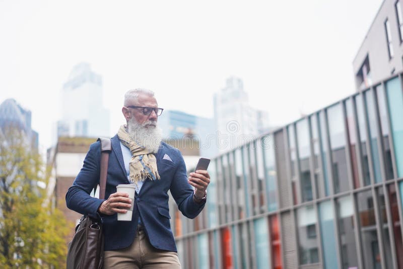 Senior Hipster Man Using Mobile Phone and Drinking Coffee on the City ...