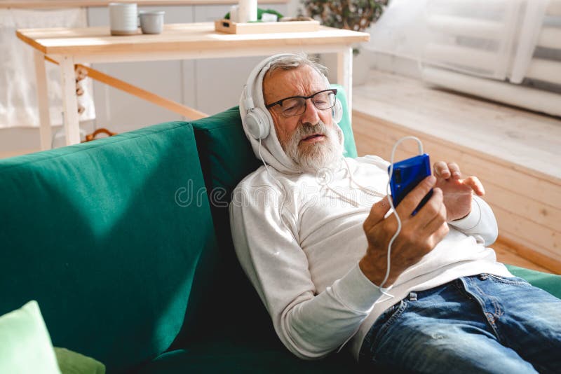 Senior Hipster Man Using Phone while Listening Playlist Music on Mobile ... Senior Hipster Man Using Phone while Listening Playlist Music on Mobile ...