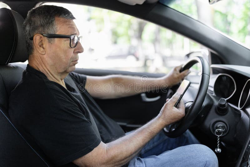 Senior in His 70s Driving a Car and Using His Mobile Phone Stock Image ...