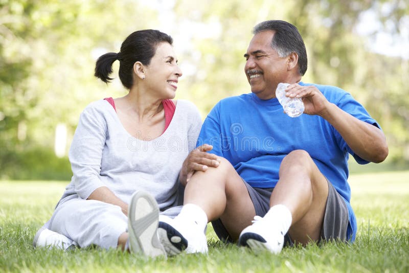 Senior Hispanic Couple Resting after Exercise Stock Photo - Image of ...