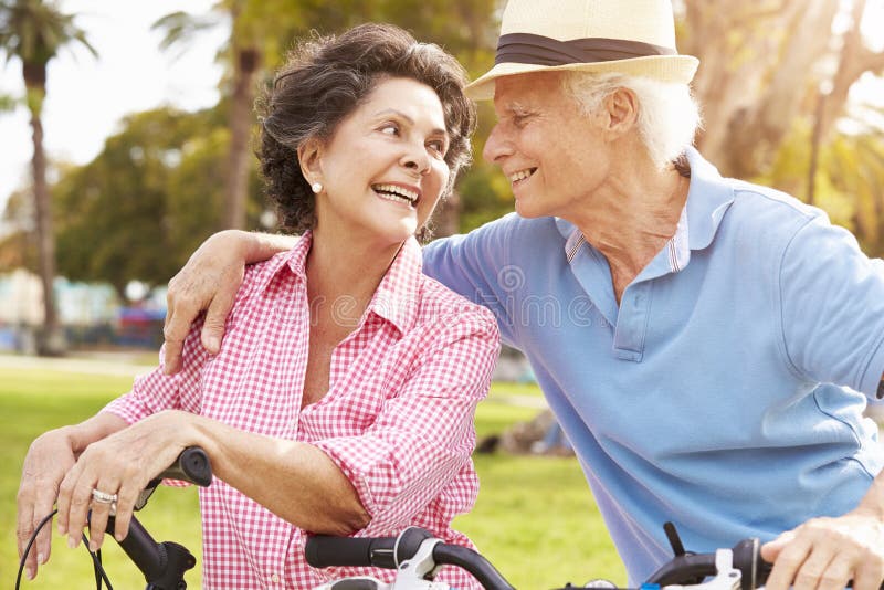 Mature couple bike riding. stock photo. Image of retirement - 5558764