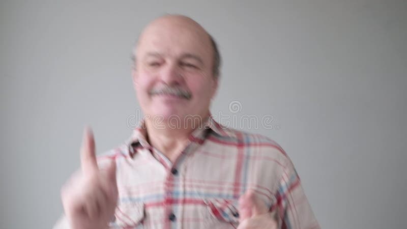 Senior Hispanic Man Dancing Pointing Aside at Studio Shot Stock Video ...