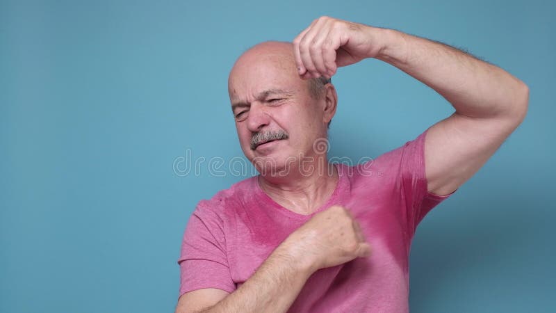 Senior Hispanic Man with Sweat Stain on it. he is Sweating Becaise of ...