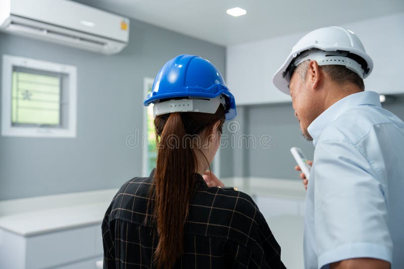 Senior Home Inspector Checking Home Defects and Teaching Young Engineers, before Handing it Over ...