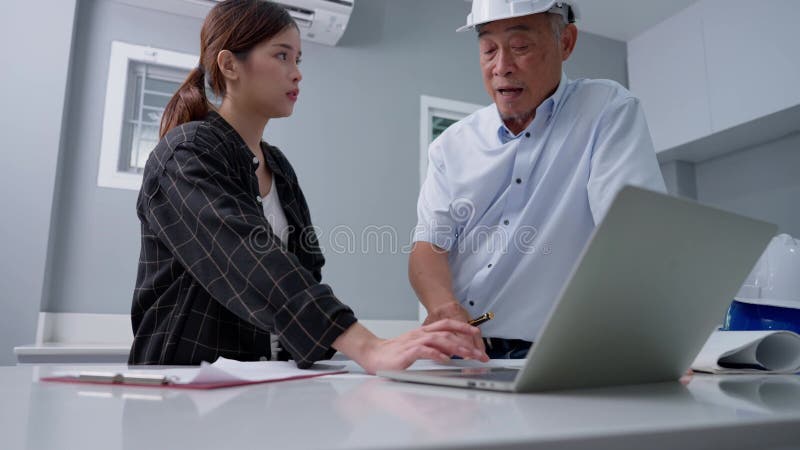 Senior Home Inspector Checking Home Defects and Teaching Young ...