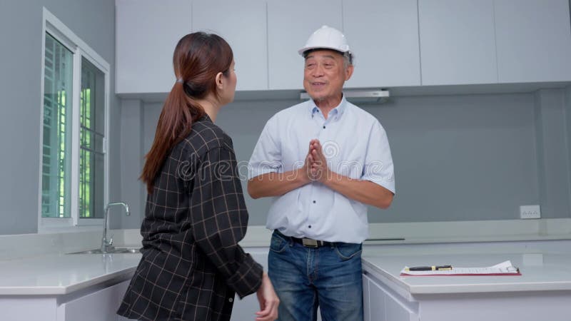 Senior Home Inspector Checking Home Defects and Teaching Young ...