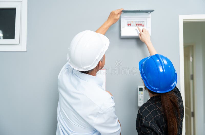 Senior Home Inspector Checking Home Defects and Teaching Young ...