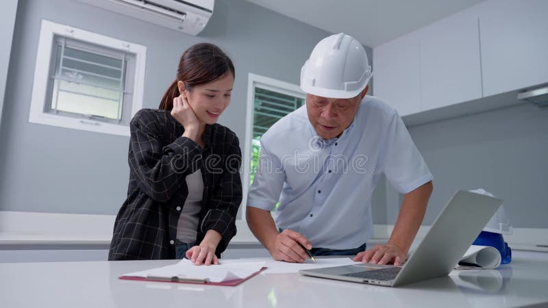 Senior Home Inspector Checking Home Defects and Teaching Young Engineers, before Handing it Over ...