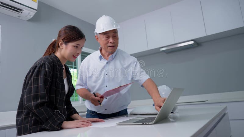 Senior Home Inspector Checking Home Defects and Teaching Young ...