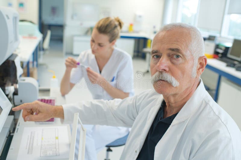 Senior Lab Worker Pointing To Computer Screen Stock Image - Image of ...