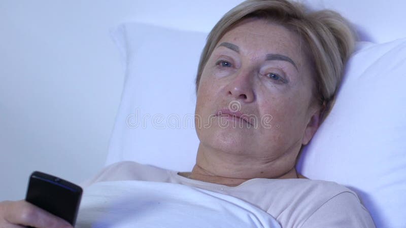 Senior Lady Falling Asleep with TV Remote Controller in Hands, Evening ...