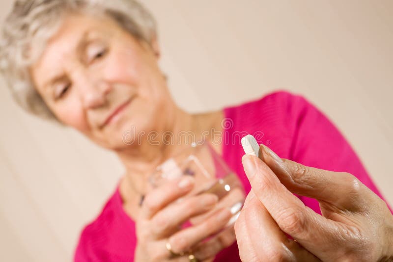 Senior Lady Holding Tablet or Pill with Water Stock Photo - Image of ...