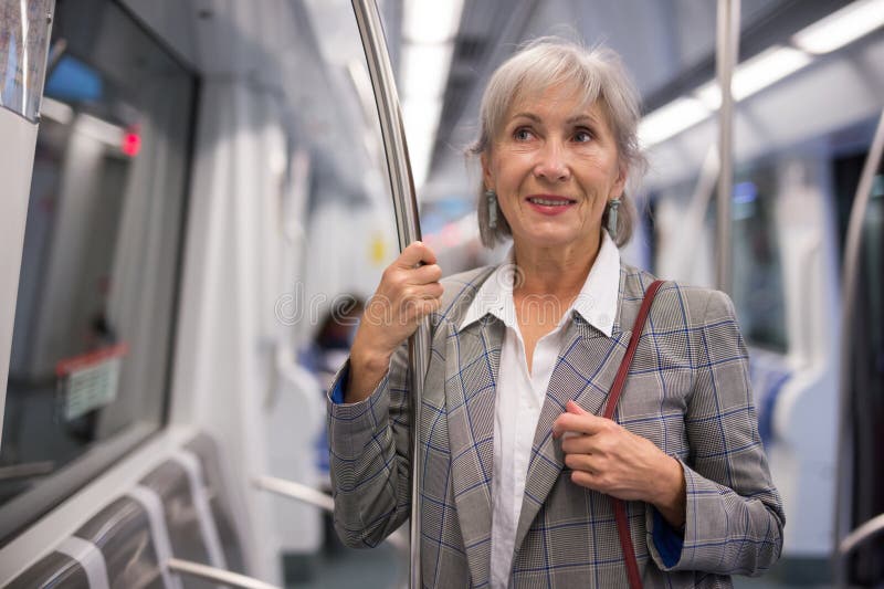 Senior Lady Standing in Metro Train Stock Photo - Image of pensioner ...