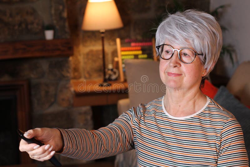 Senior Lady Using Remote Control Stock Photo - Image of haired, control ...