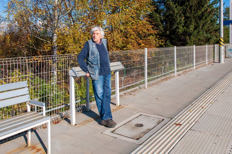 Senior Leaning on a Lean Bench Waiting for a Train on a Platform Stock ...