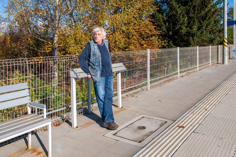 Senior Leaning on a Lean Bench Waiting for a Train on a Platform Stock ...