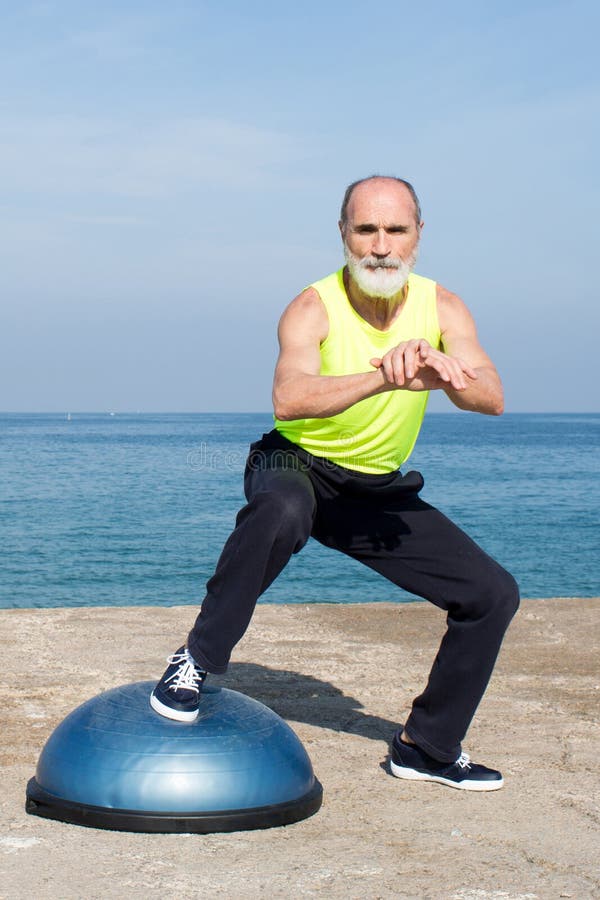 Senior Making an Exercise on a Balance Platform Stock Photo - Image of ...