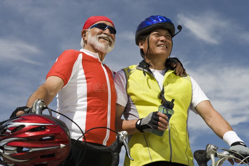 Senior Male Cyclists Standing Against Sky Stock Image - Image of ...
