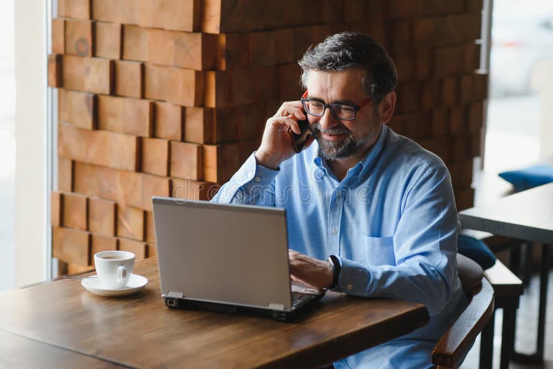Senior Male Freelancer Working on Laptop in Cafe. Remote Work Concept ...
