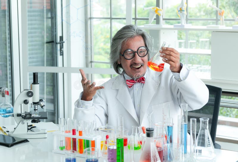 Senior Male Supervisor Doing Experiments and Researchers Working in the ...