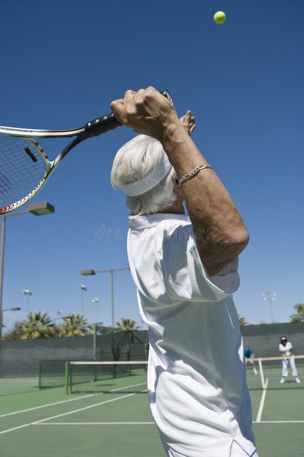 Senior Male Tennis Player Serving Stock Photo - Image of people, active ...
