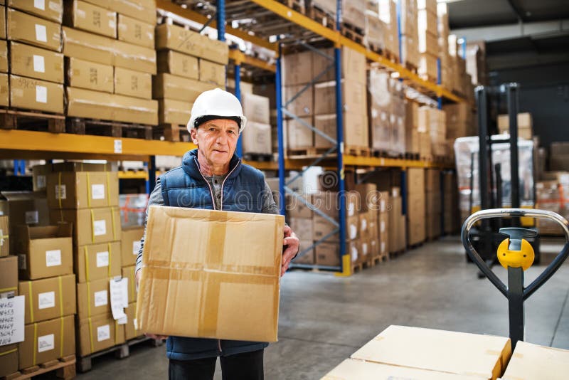Senior Male Warehouse Worker Unloading Boxes from a Pallet Truck. Stock ...