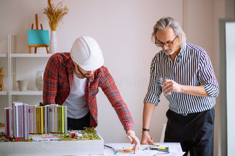 Senior Man Architect Controls the Process of Creating Building Model by ...