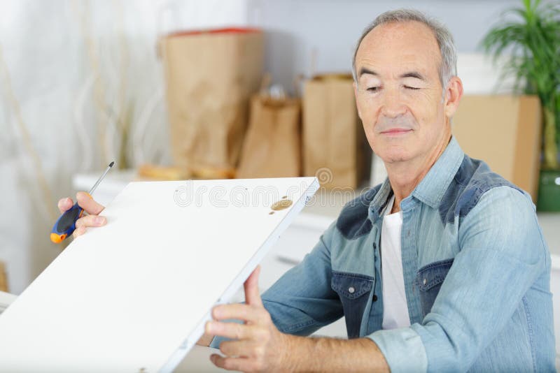 Senior Man Assembling Cupboard Checking Door Straight Stock Photo ...