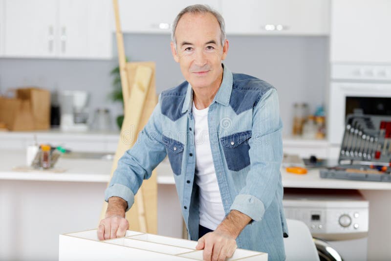 Senior Man Assembling Flat Pack Furniture Stock Photo - Image of ...