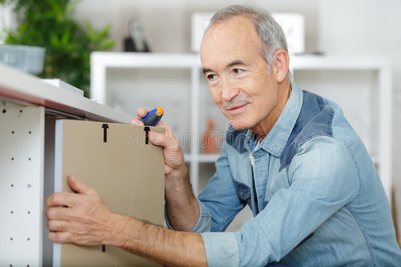 Senior Man Assembling Kitchen Base Cupboard Stock Image - Image of ...