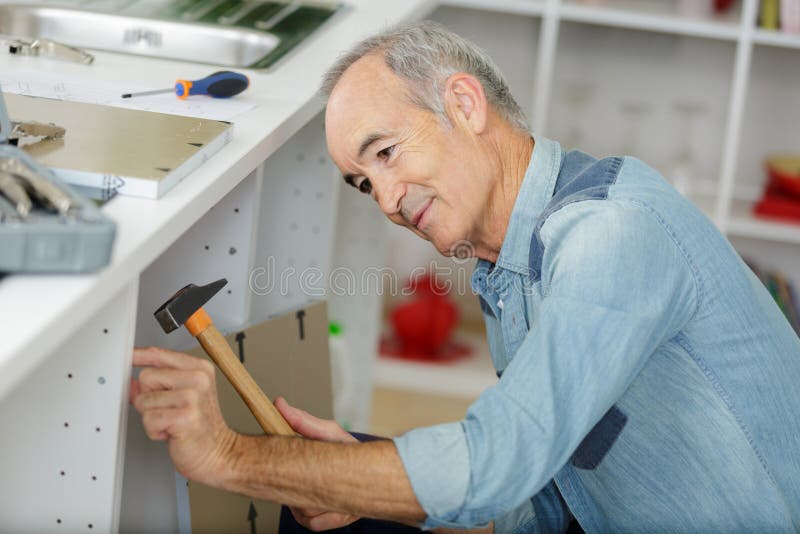 Senior Man Assembling Kitchen Base Units Stock Image - Image of casual ...
