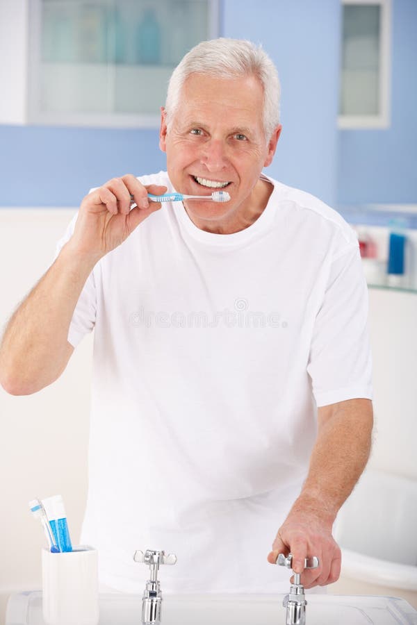 Senior man brushing teeth stock photo. Image of happy - 23959006