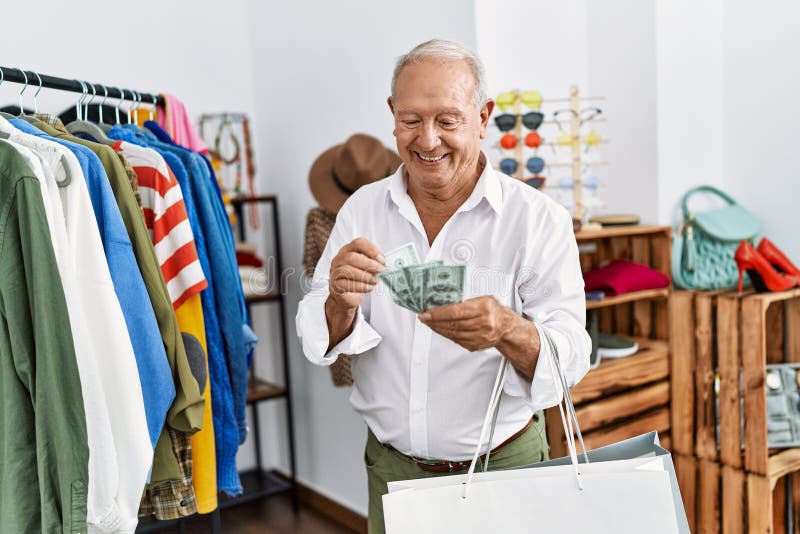 Senior Man Customer Smiling Confident Counting Dollars at Clothing ...