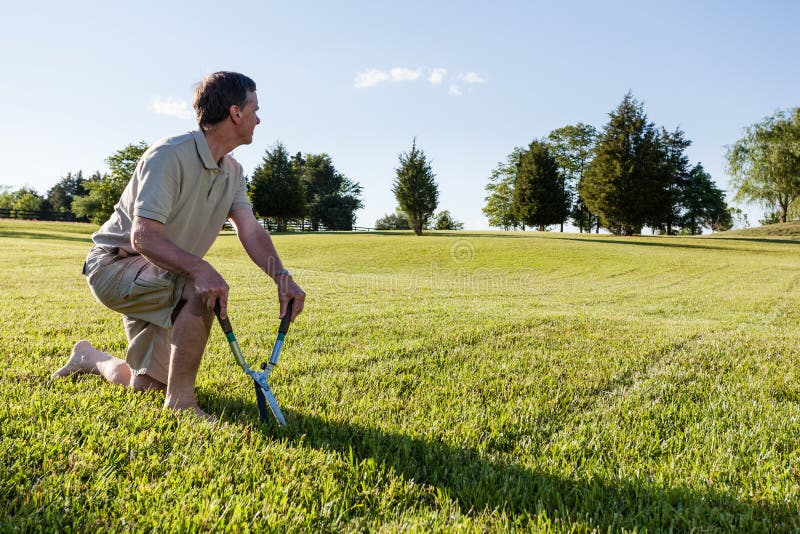 Man Cutting Grass with Scissors Stock Image - Image of senior, farm ...