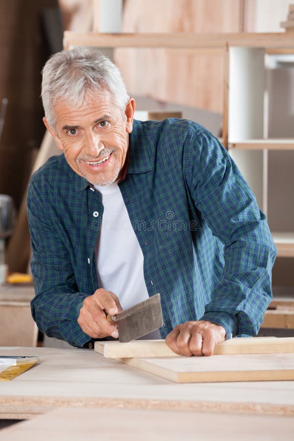 Senior Man Cutting Wood with Saw in Workshop Stock Photo - Image of ...