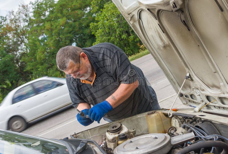 Senior Man Doing Car Repair Stock Photo - Image of attractive, alone ...