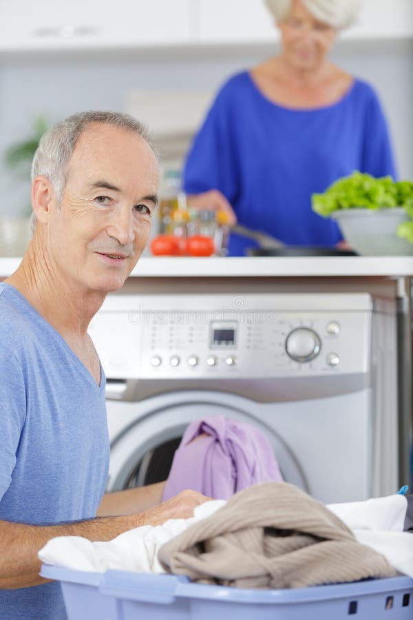 Senior man doing laundry stock image. Image of lifestyle - 254759371