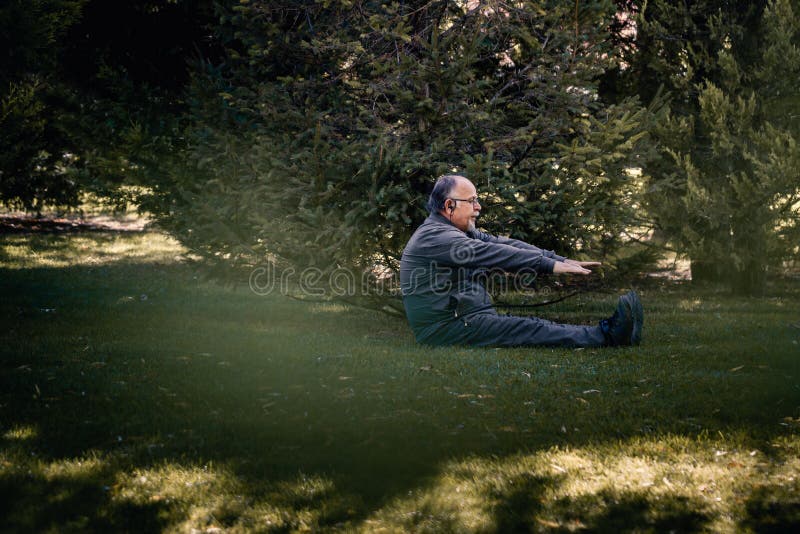 Senior Man Doing Physical Exercise in a Green Park Stock Image - Image ...