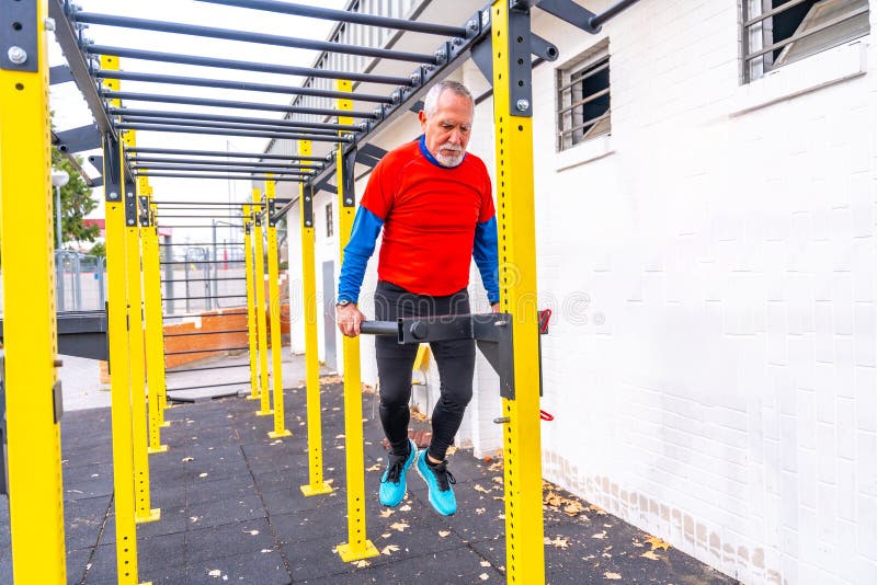Senior Man Doing Pull Ups in an Outdoor Sports Ground Stock Photo ...