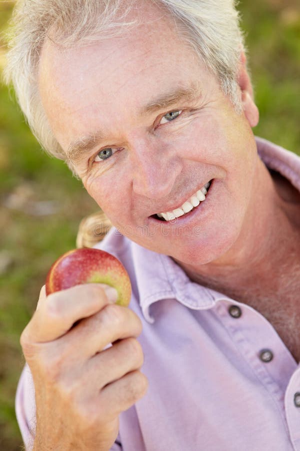 Senior Man Eating Apple Smiling Stock Image - Image of happy, confident ...