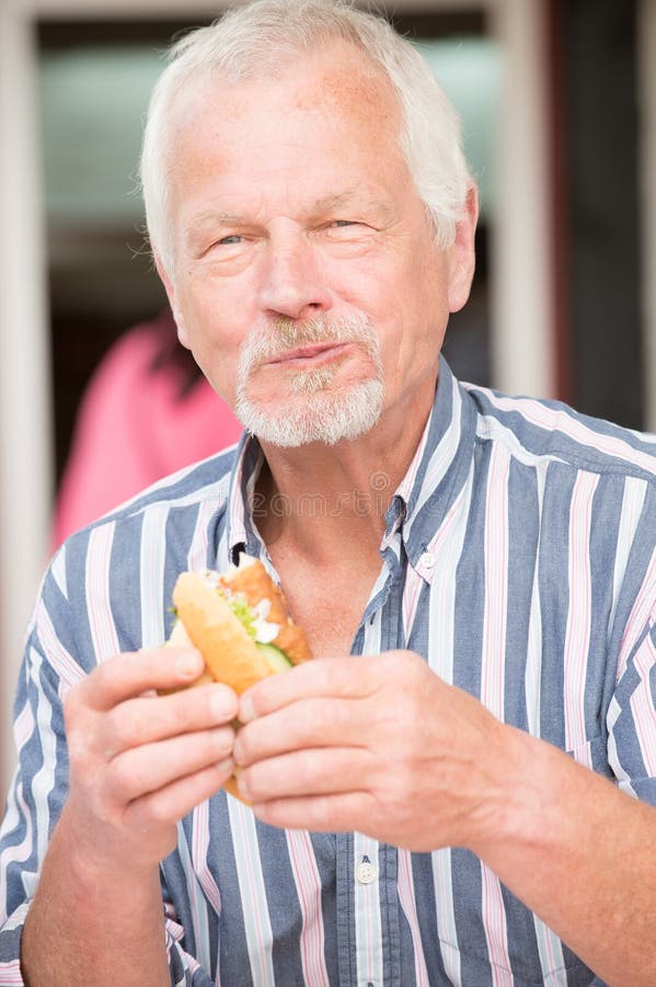 Senior man eating fish stock image. Image of male, fish - 32021305
