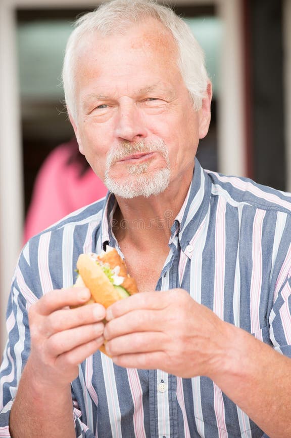 Senior man eating fish stock image. Image of male, fish - 32021305