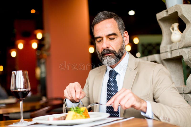 Senior Man Eating Lunch in Restaurant Stock Photo - Image of mealtime ...