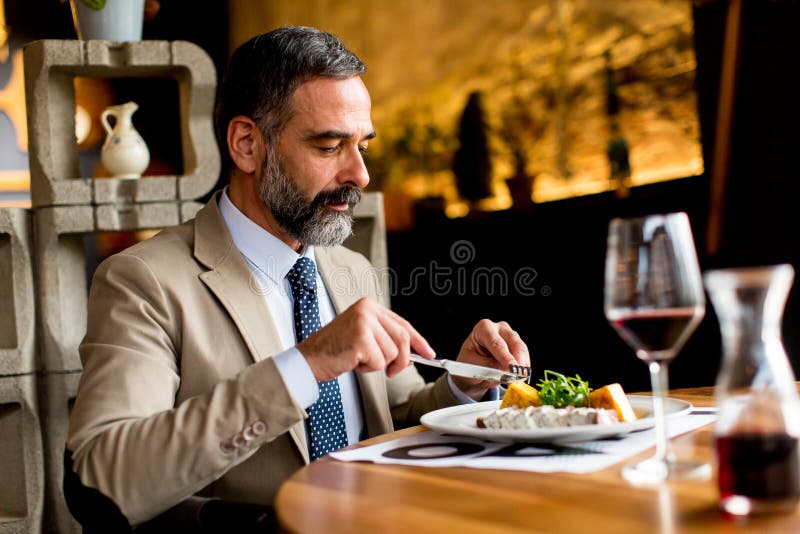 Senior Man Eating Lunch in Restaurant Stock Photo - Image of wine ...
